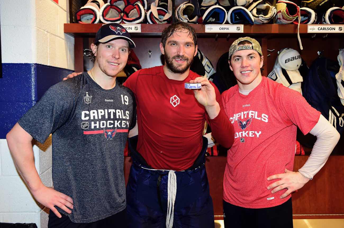 Alex Ovechkin poses with milestone 1,000 point puck along with Nicklas ...