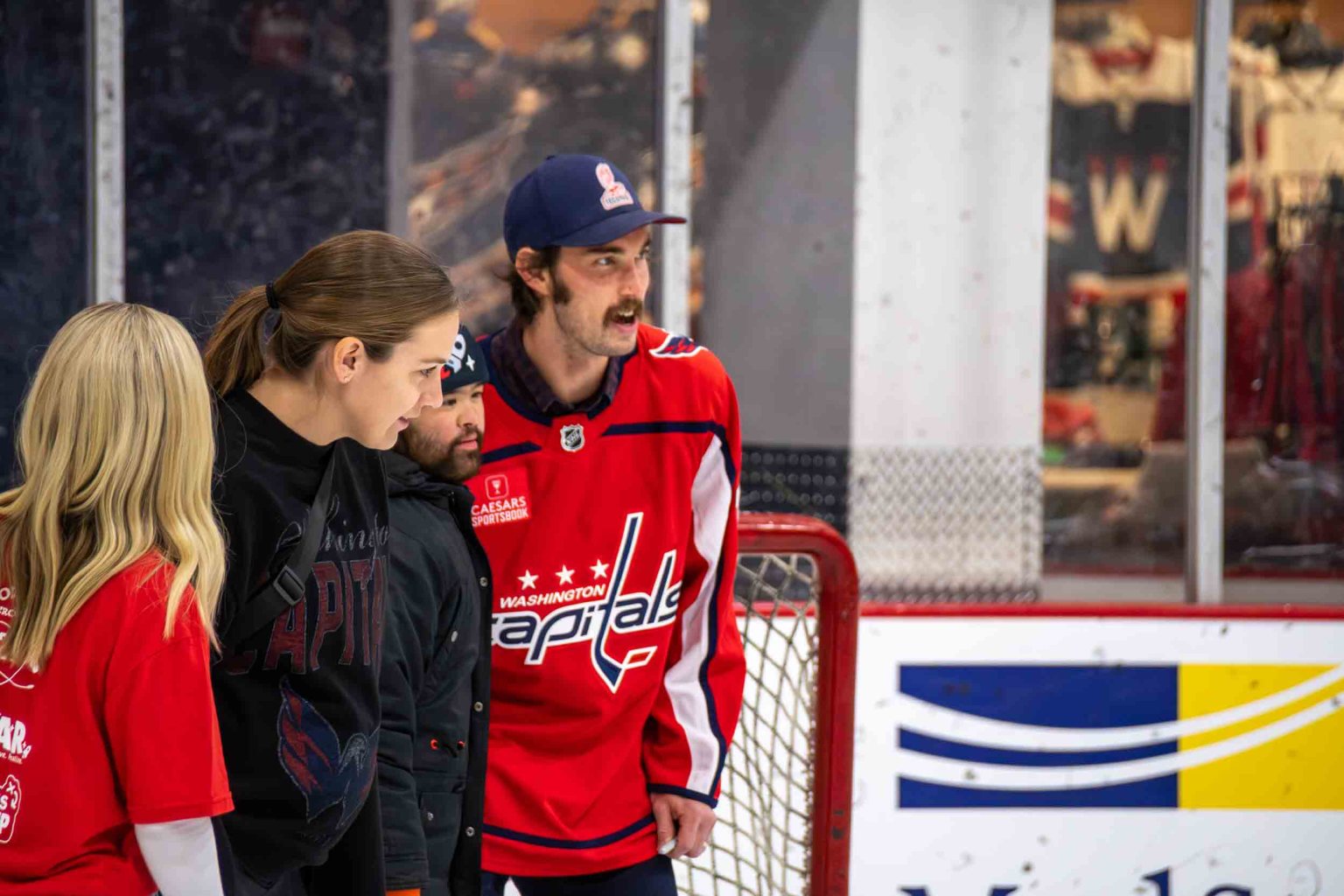 Charlie Lindgren and Nic Dowd help host adaptive skate for children with disabilities